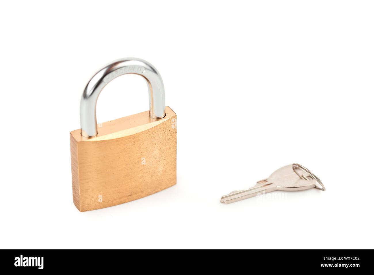 Padlock with key against white background Stock Photo - Alamy