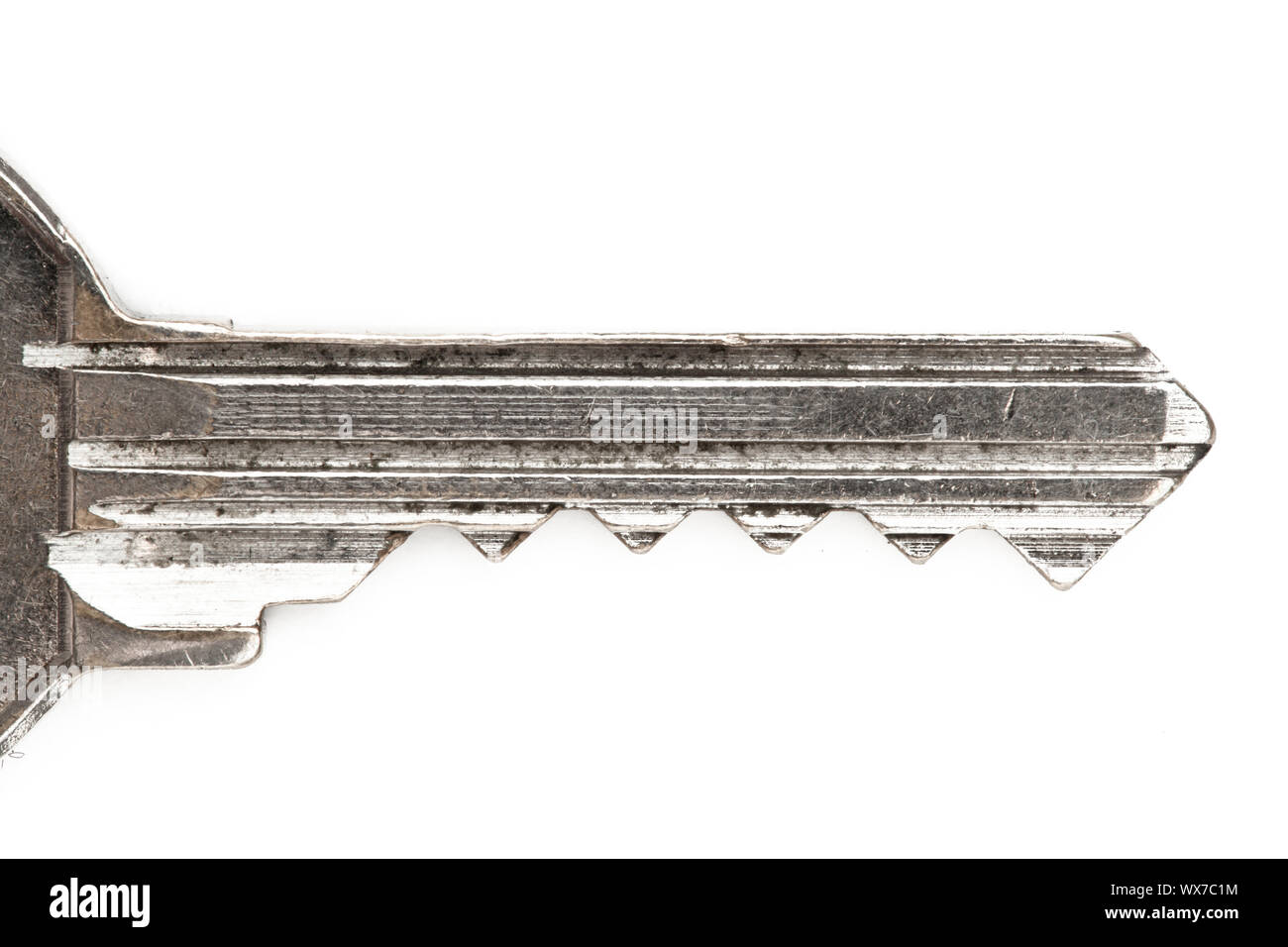 Silver key against white background close-up Stock Photo - Alamy
