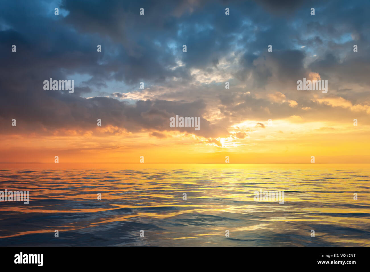 a golden sunset at the ocean Stock Photo - Alamy