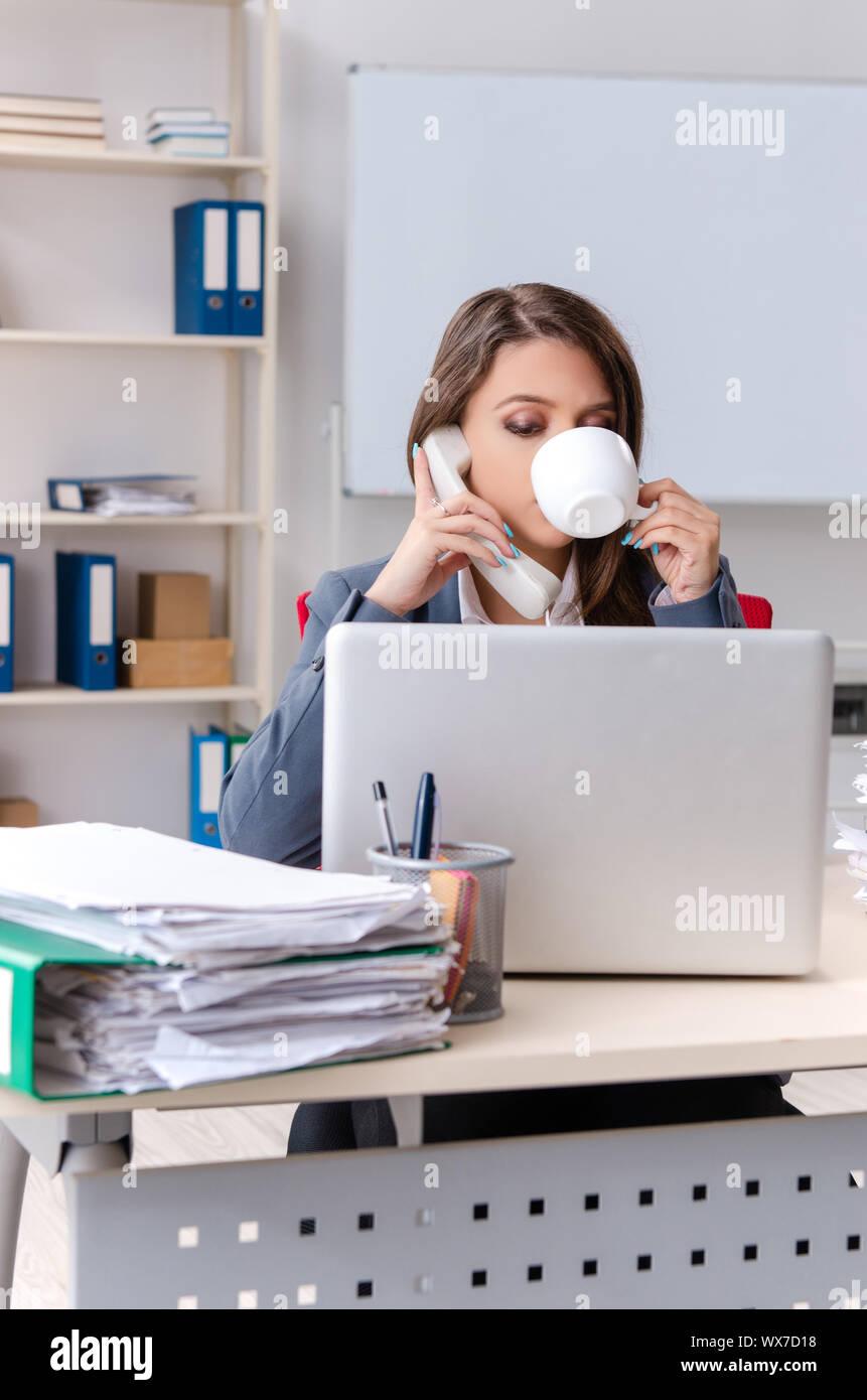 Beautiful female employee unhappy with excessive work Stock Photo - Alamy
