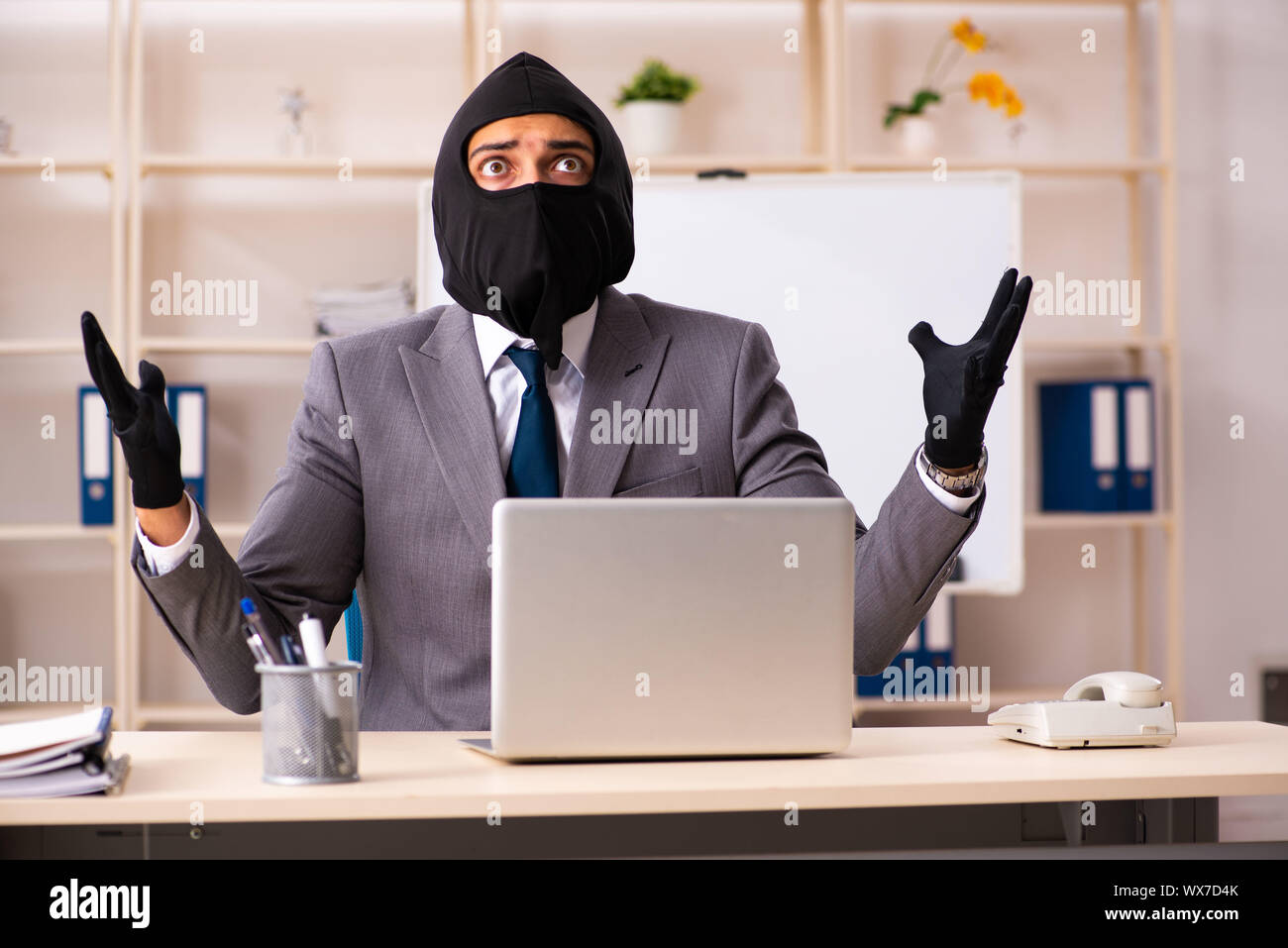 Male gangster stealing information from the office Stock Photo - Alamy