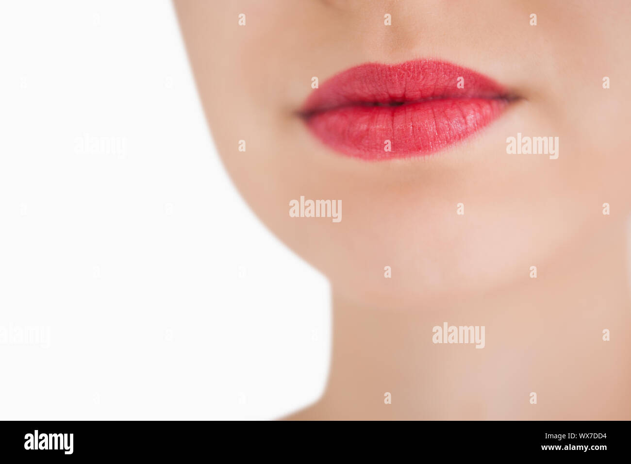 Woman's half face wearing red lipstick against white background Stock ...