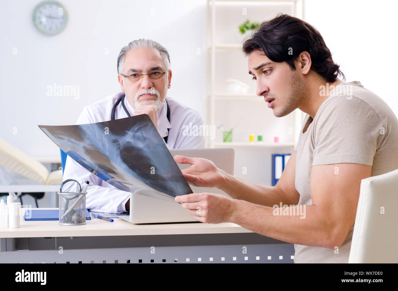 Young man visiting old male doctor radiologist Stock Photo - Alamy