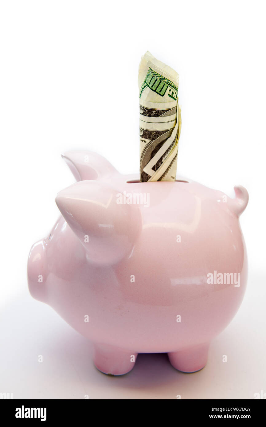 Dollar bills in a piggy bank against white background Stock Photo - Alamy