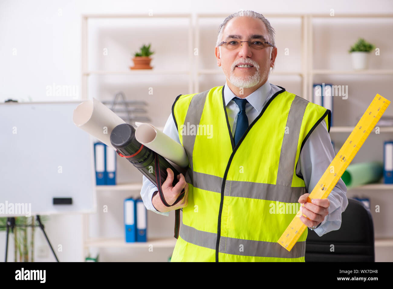 Aged construction engineer working in the office Stock Photo - Alamy
