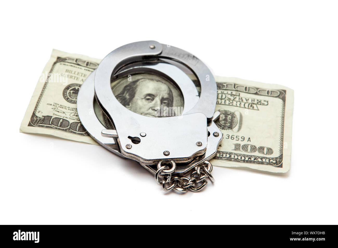 Money and handcuffs lying against white background Stock Photo - Alamy