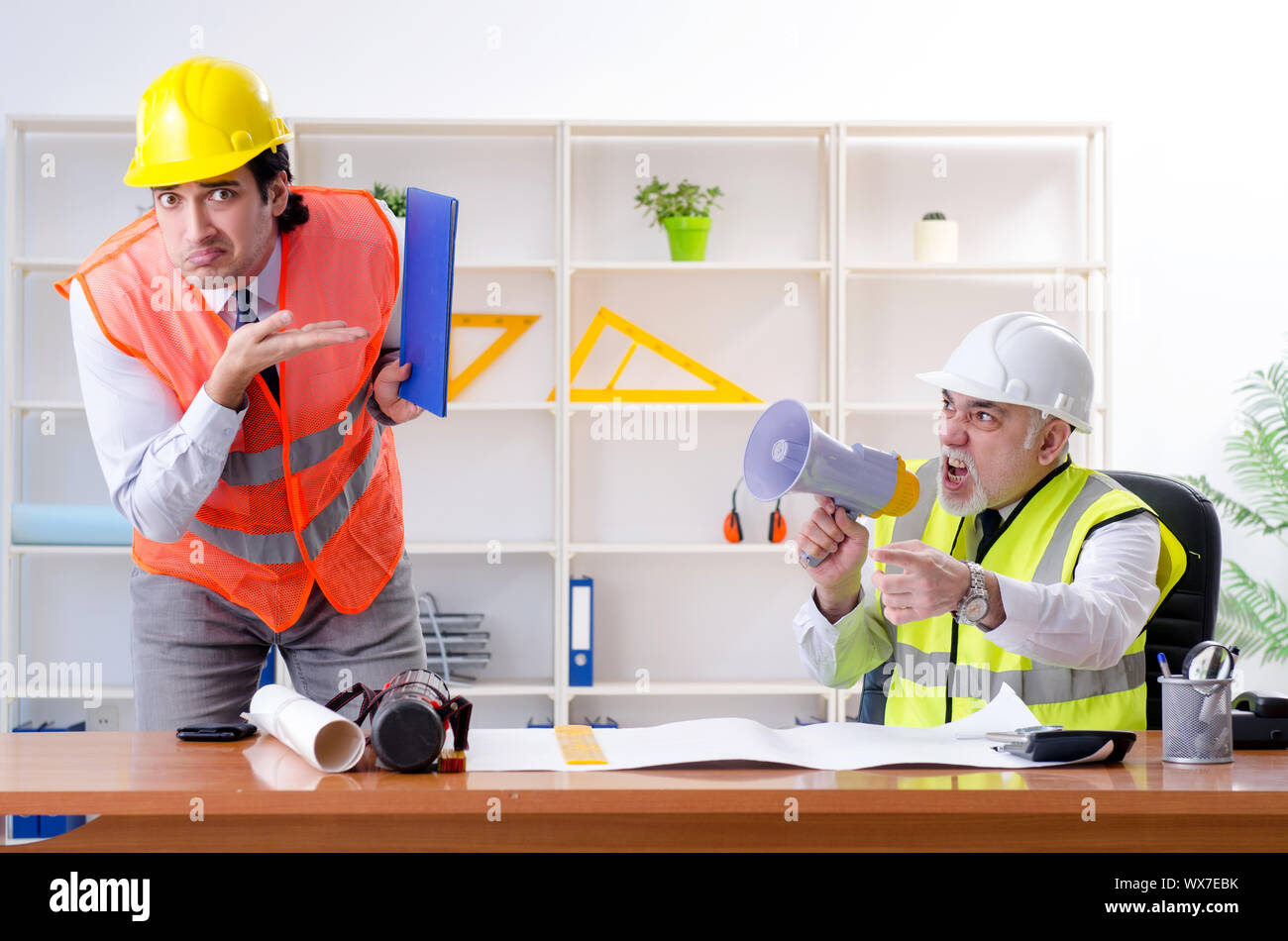 Two engineers colleagues working under project Stock Photo - Alamy