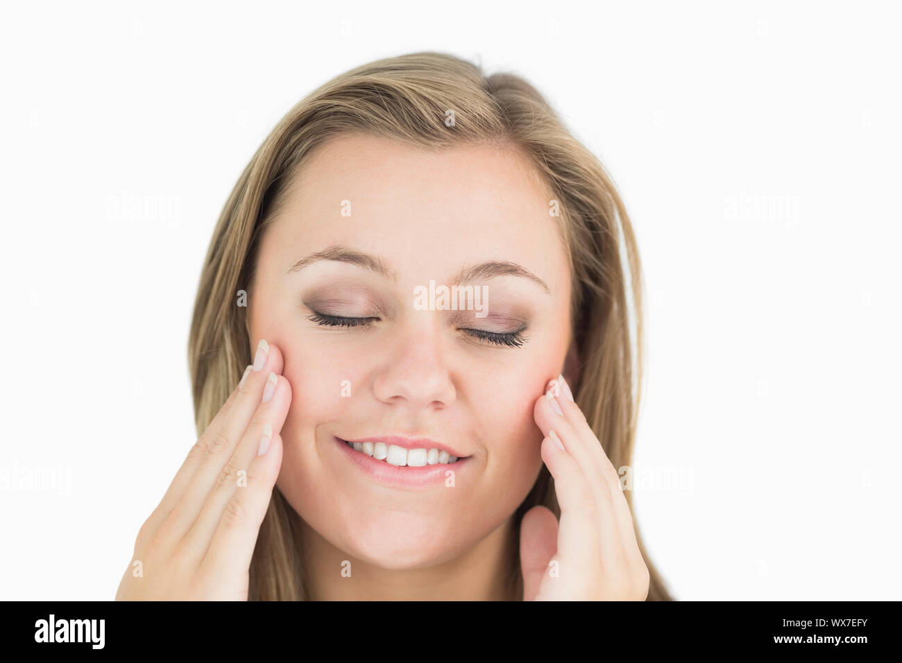 Pretty woman putting her hands on face on the white background Stock ...