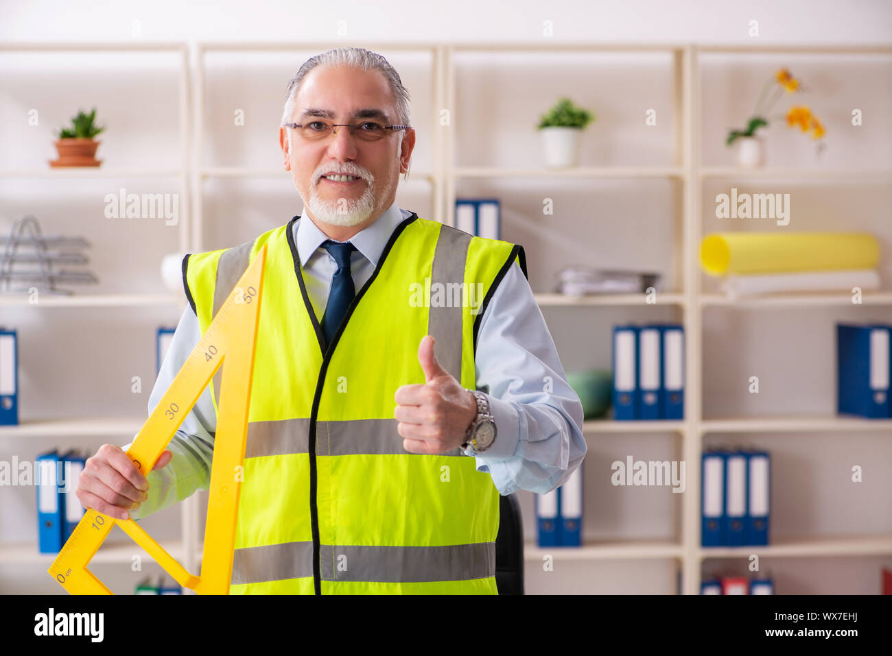 Aged construction engineer working in the office Stock Photo - Alamy