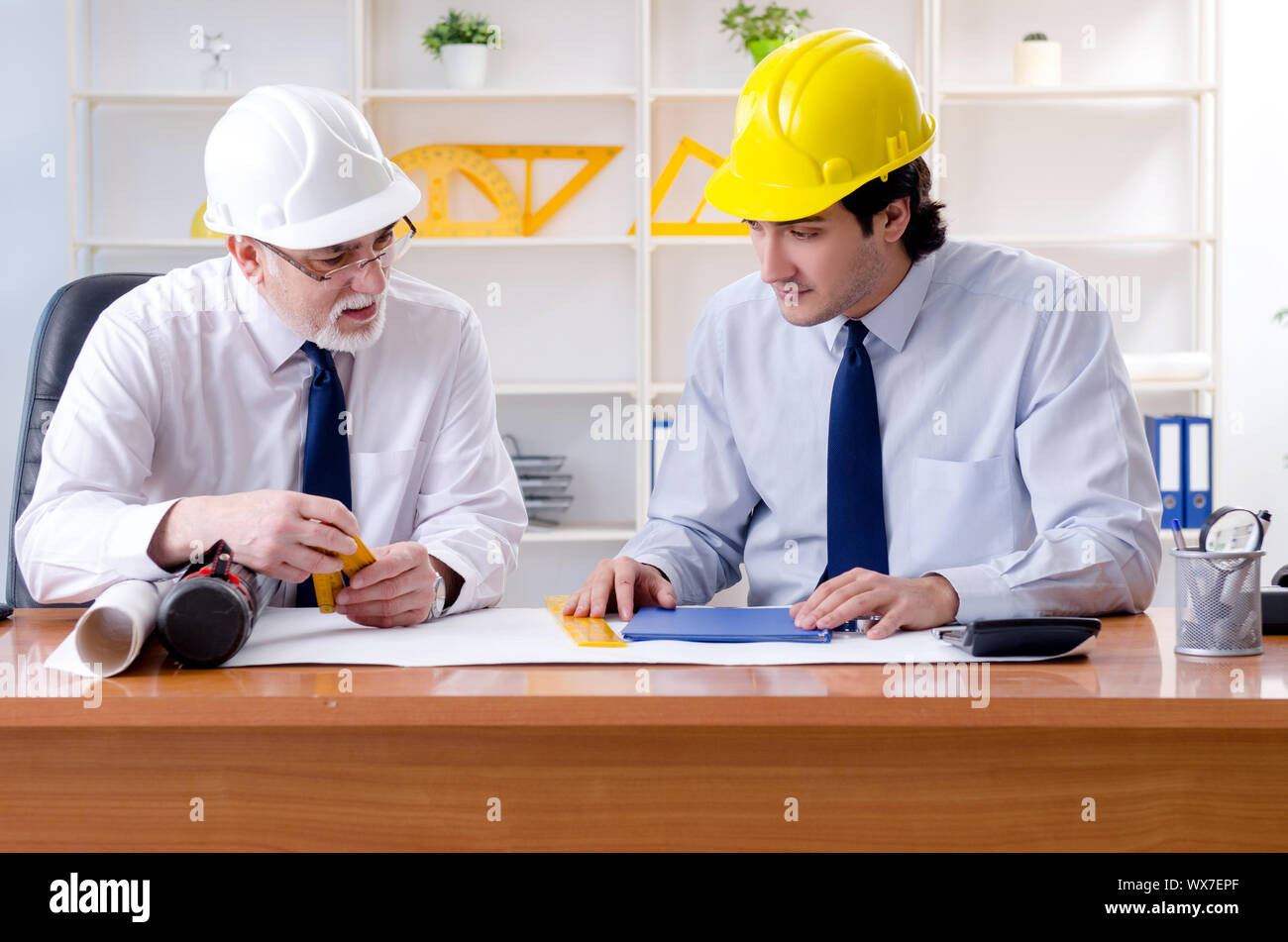 Two engineers colleagues working under project Stock Photo - Alamy