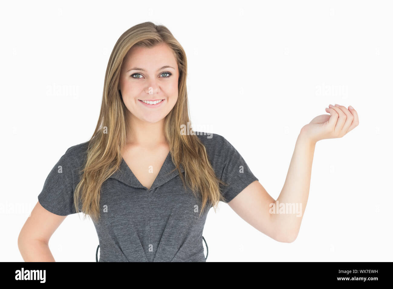 Woman presenting with her hand on white background Stock Photo - Alamy
