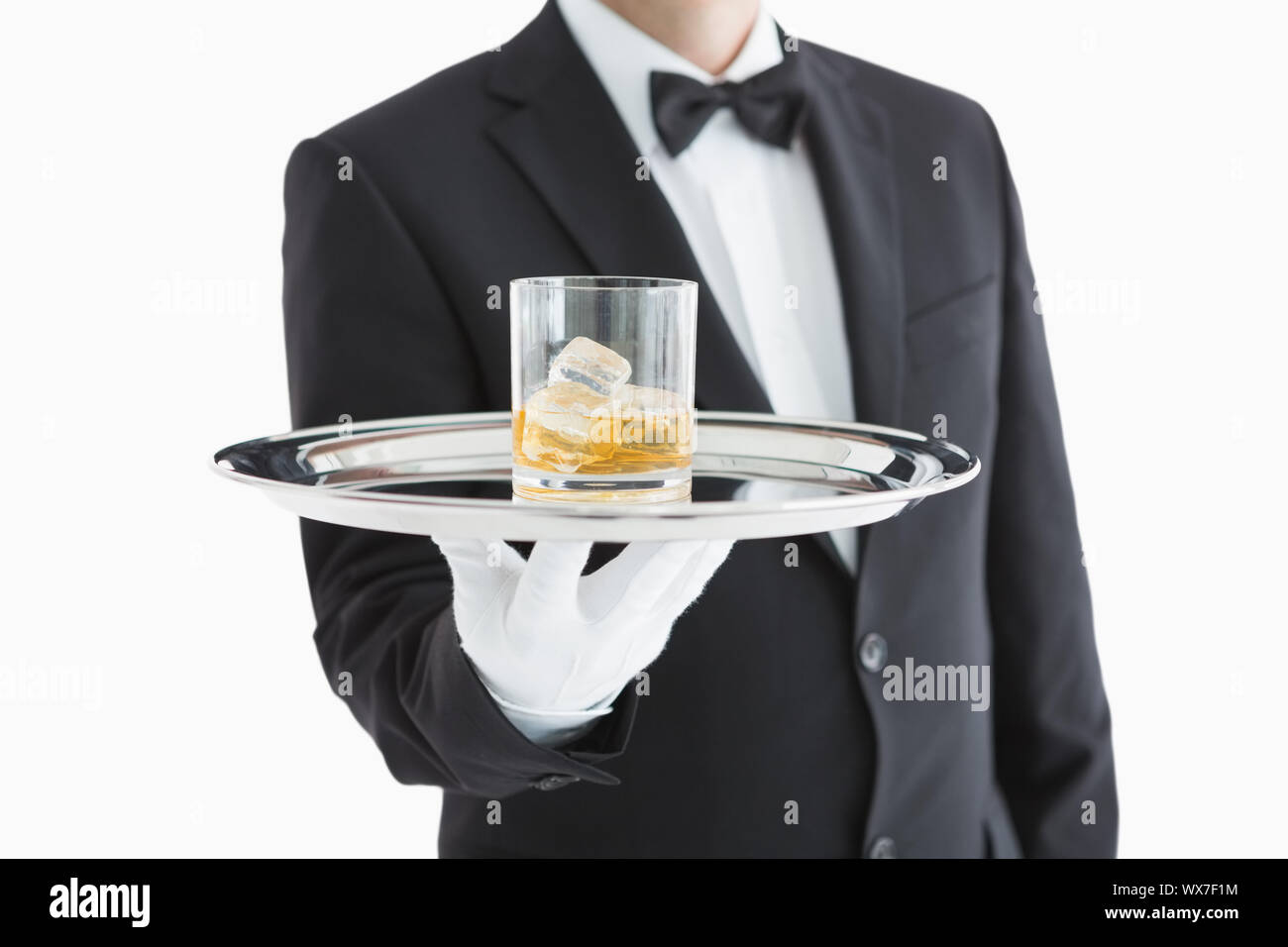Man serving whiskey on a silver tray Stock Photo - Alamy