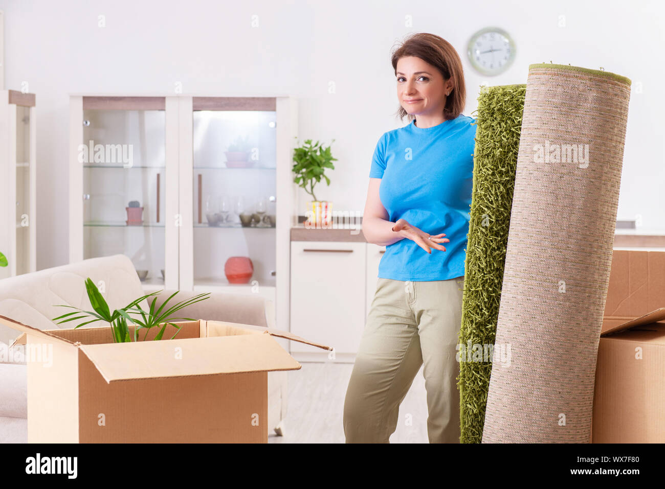 Middle-aged woman moving to new flat Stock Photo - Alamy