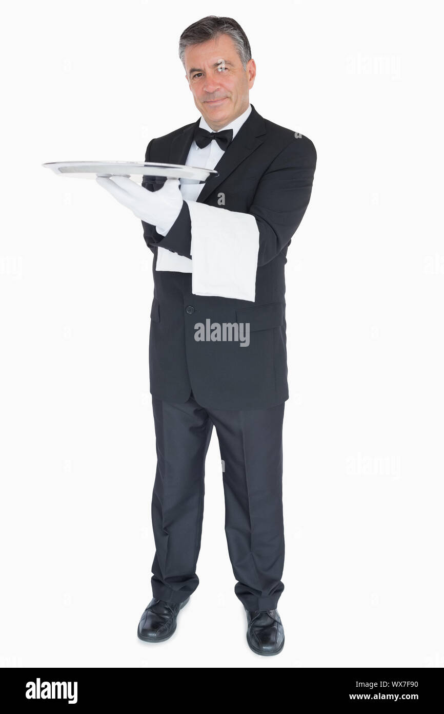 Happy waiter with silver tray and towel over his arm Stock Photo - Alamy