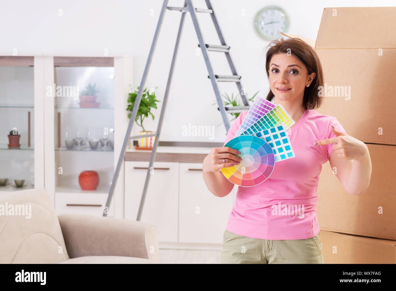 Woman choosing color for flat renewal Stock Photo - Alamy