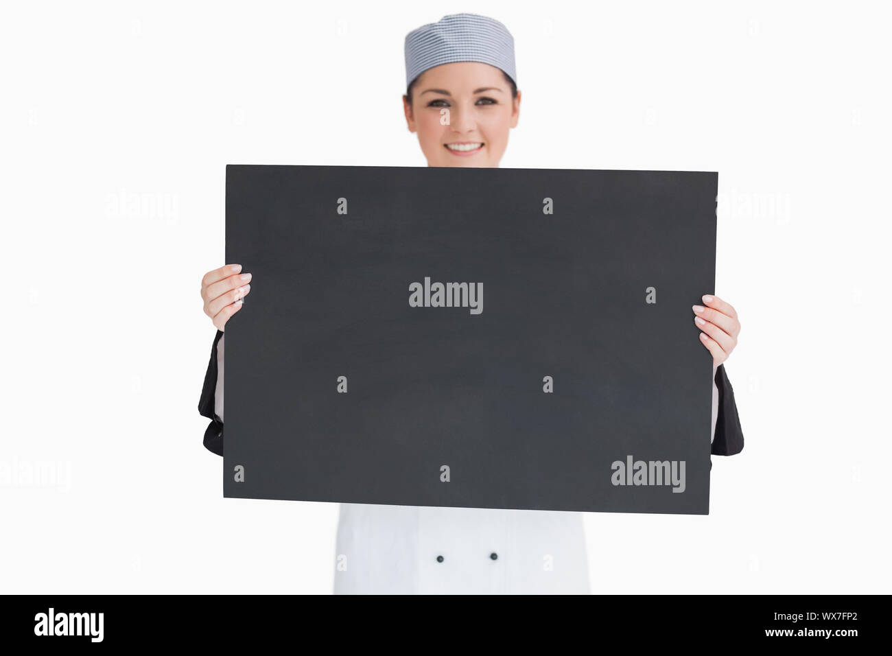 Cook holding and showing a blackboard on white background Stock Photo ...