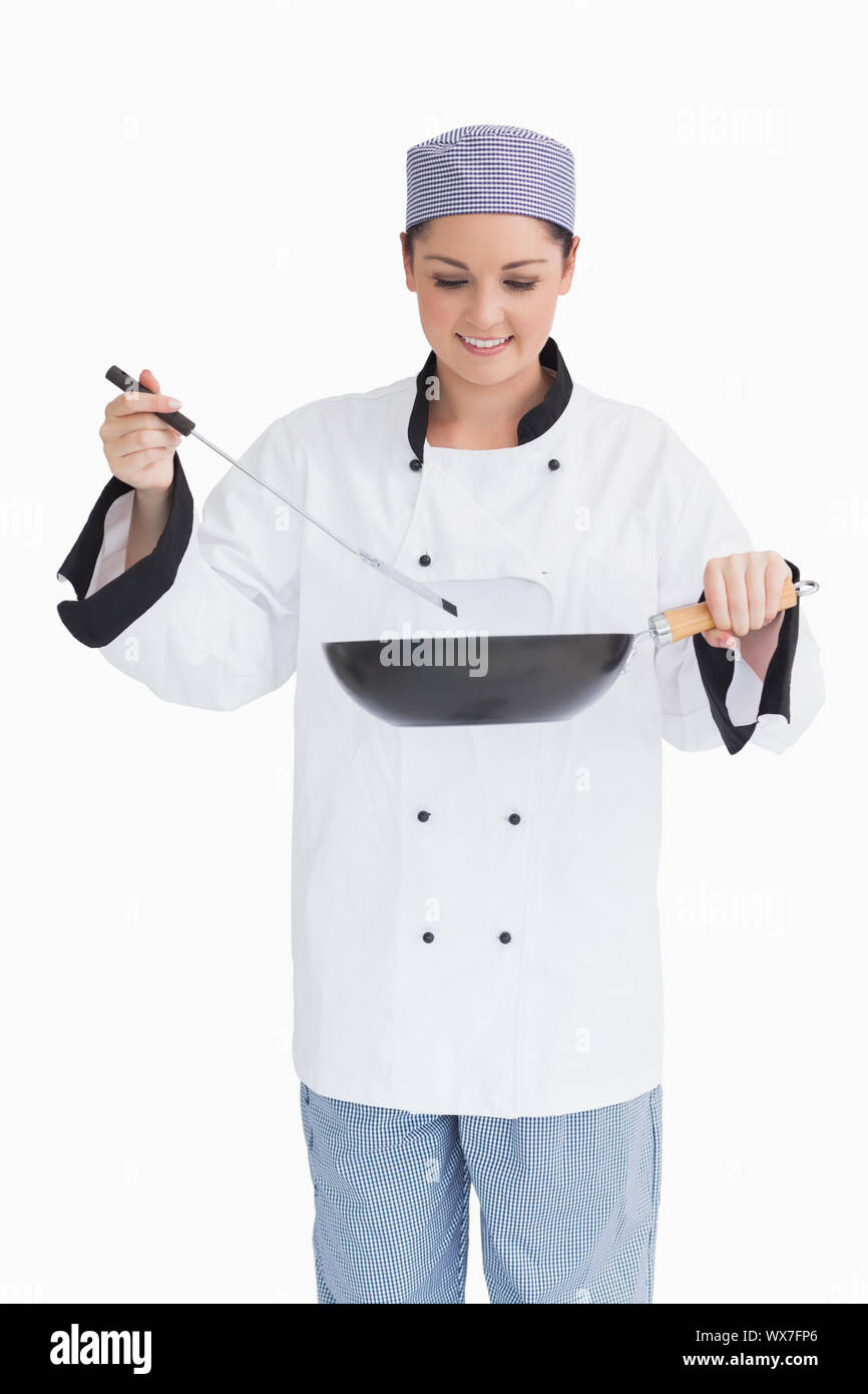 Smiling cook cooking with wok and spoon on a white background Stock ...
