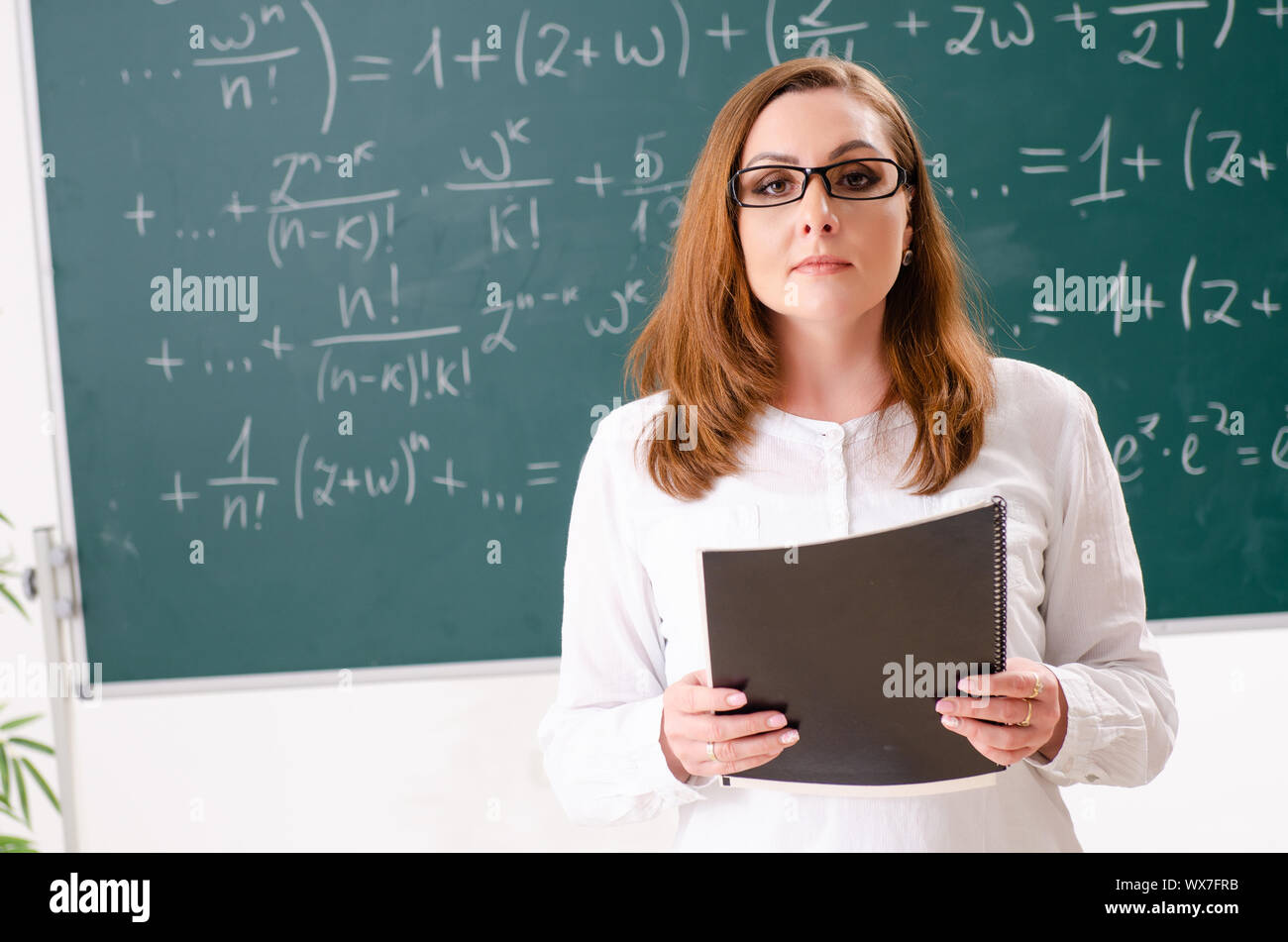 Female math teacher in the classroom Stock Photo - Alamy