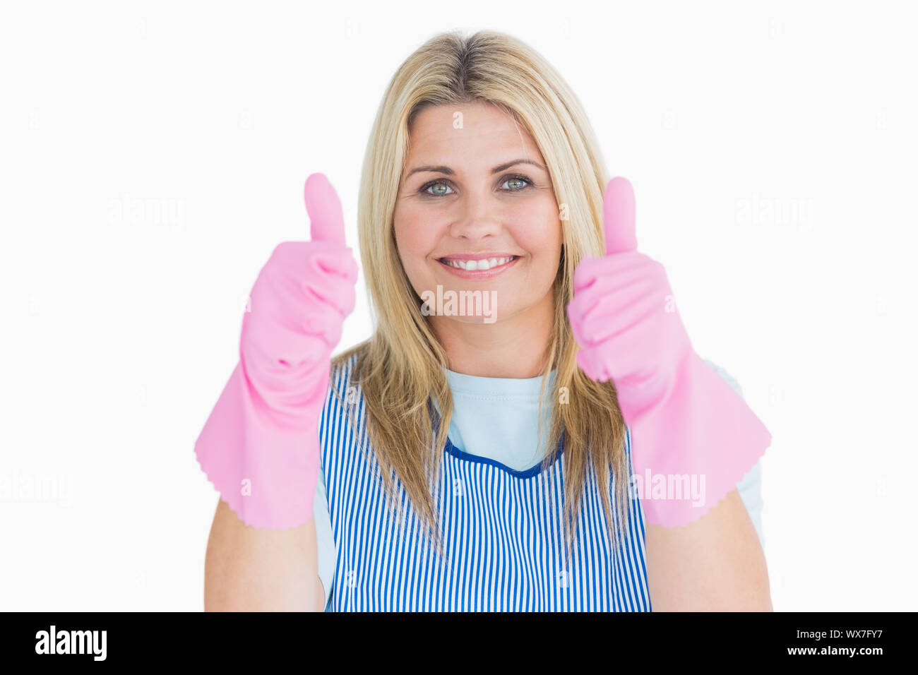 Cheerful cleaner putting thumbs up with pink gloves in the white ...