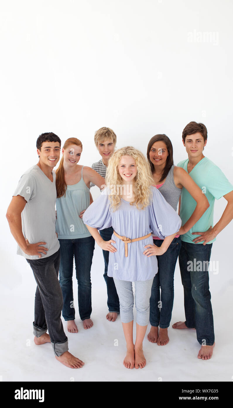 Group of smiling friends standing against white background with copy ...