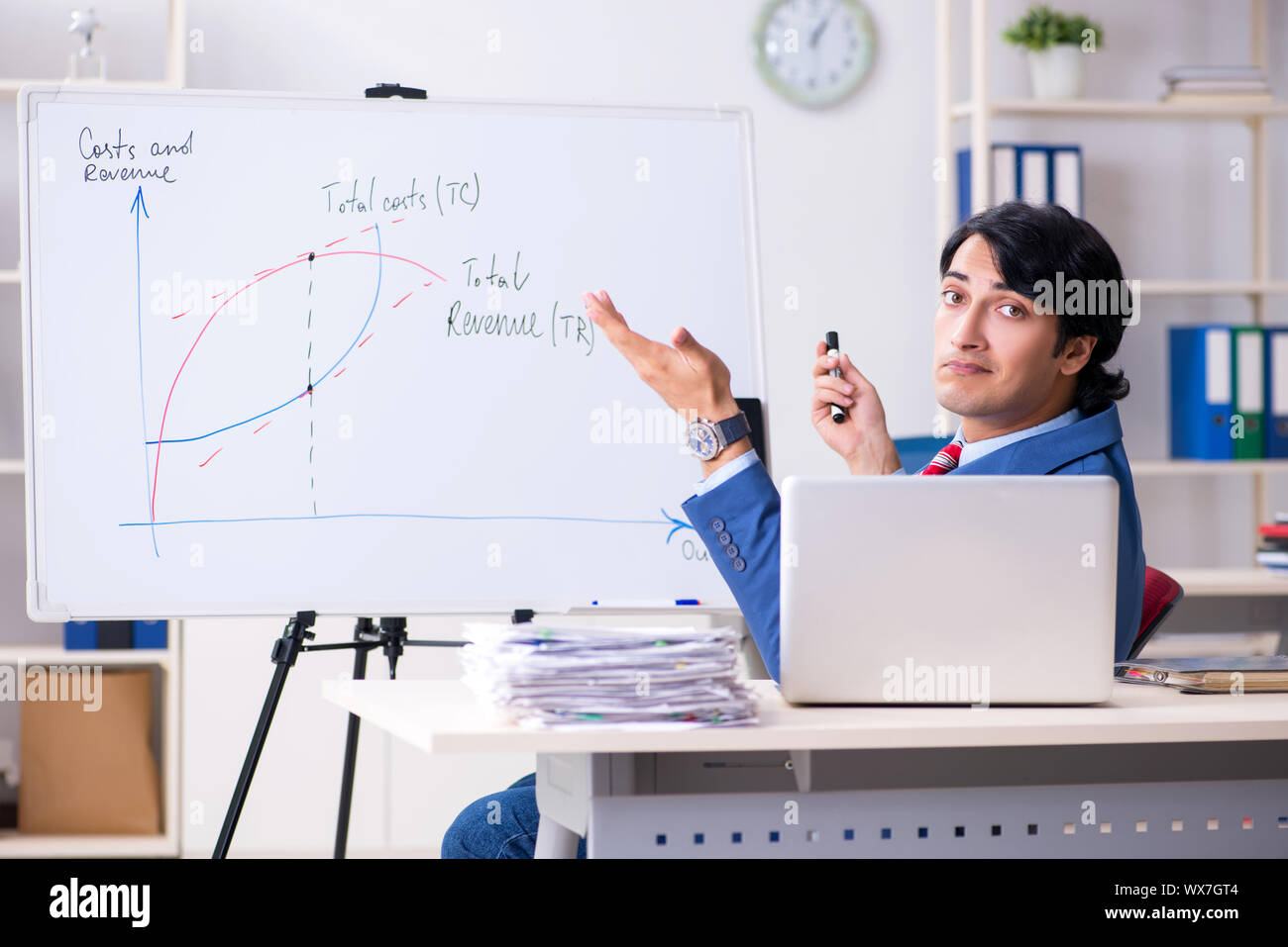 Busy businessman explaining business charts Stock Photo - Alamy