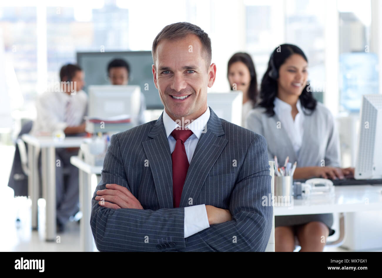 Attractive smiling manager leading his team in a call center Stock ...