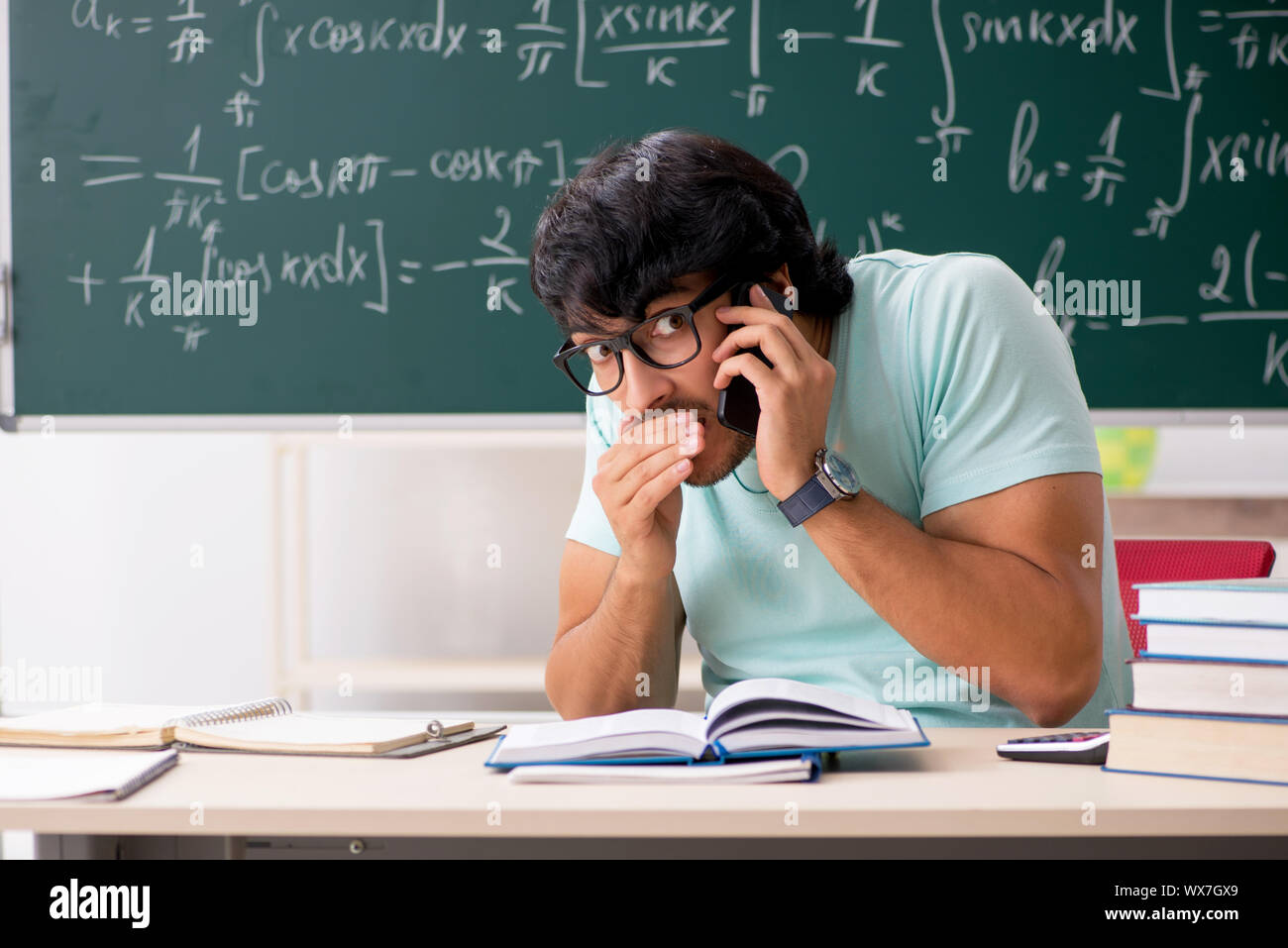 Young male student mathematician in front of chalkboard Stock Photo - Alamy