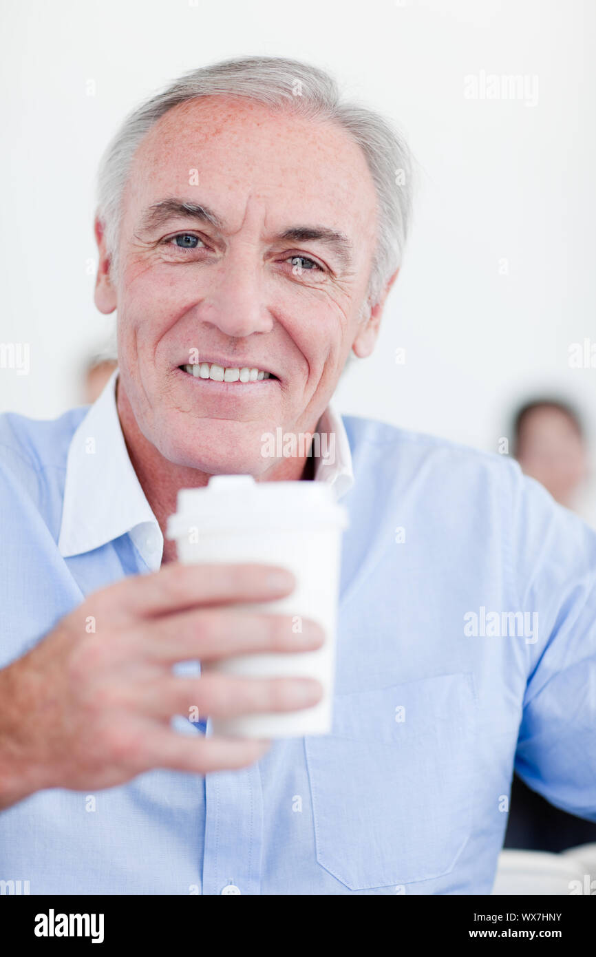 Senior businessman drinking a tea in the office Stock Photo - Alamy