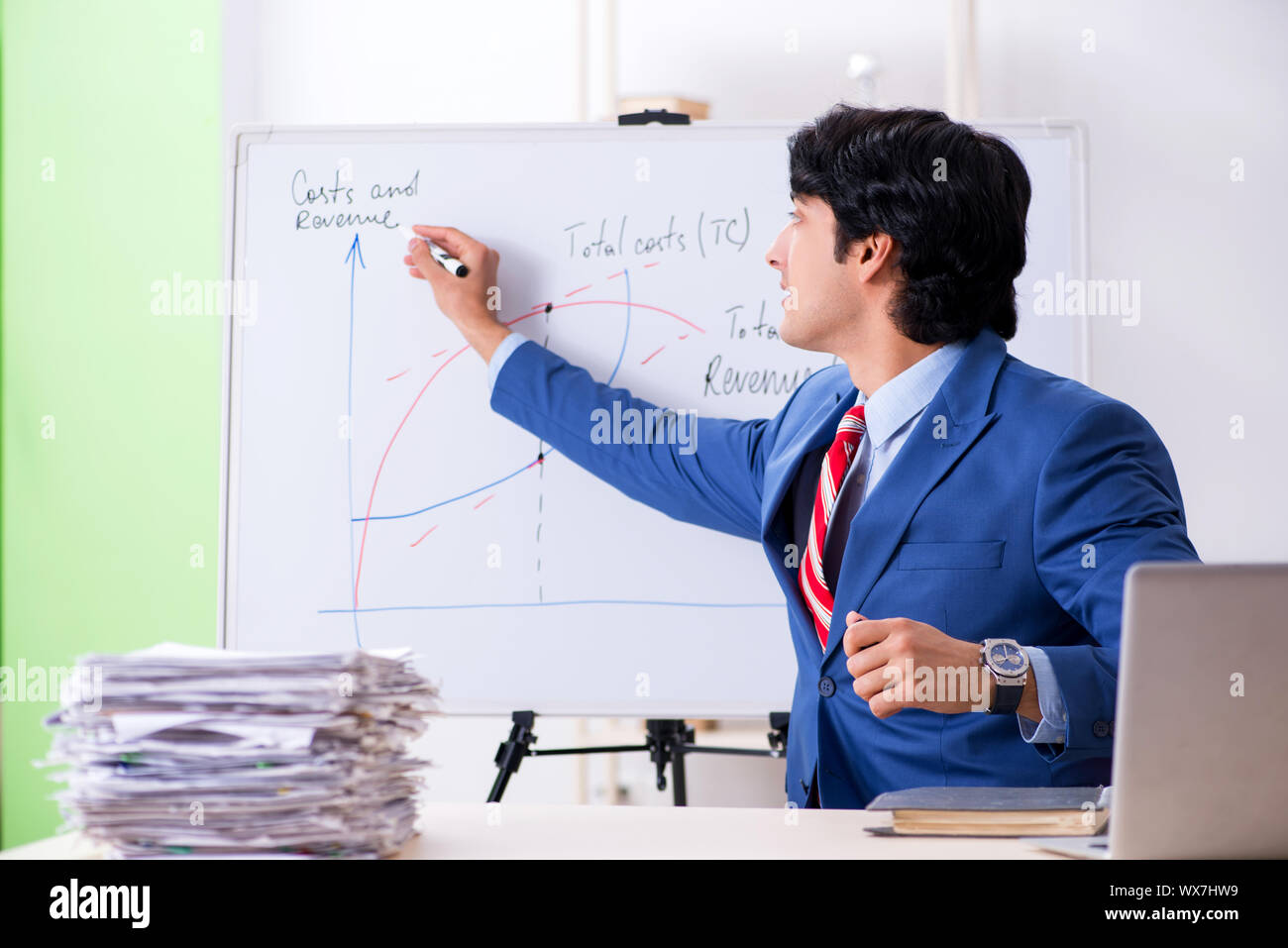 Busy businessman explaining business charts Stock Photo - Alamy