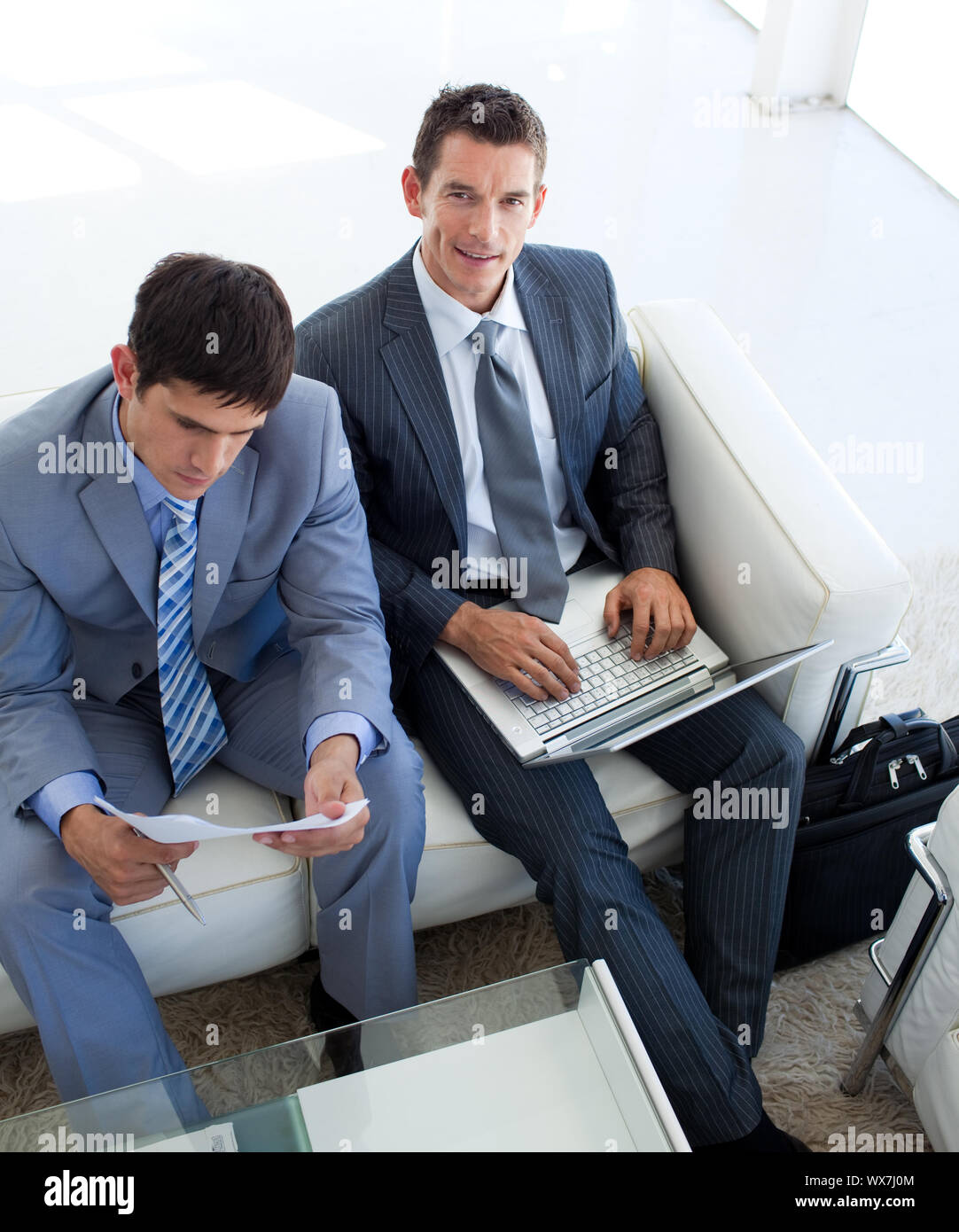 Attractive Businessmen relaxing before a job interview in a waiting ...
