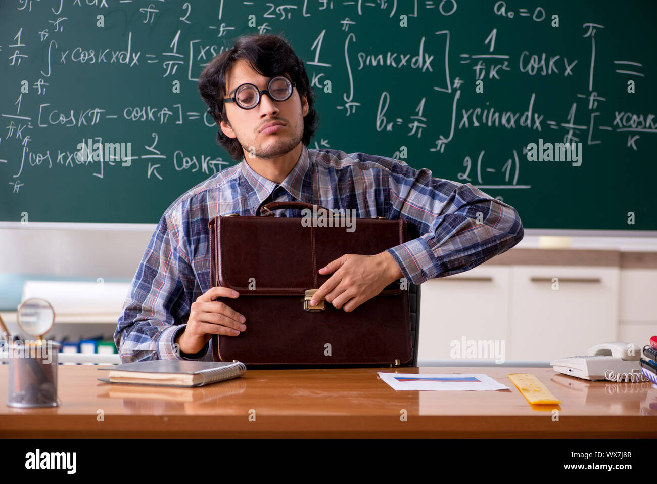 Funny male math teacher in the classroom Stock Photo - Alamy
