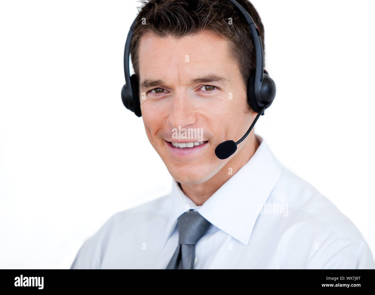 Confident sales representative man with an headset against white ...