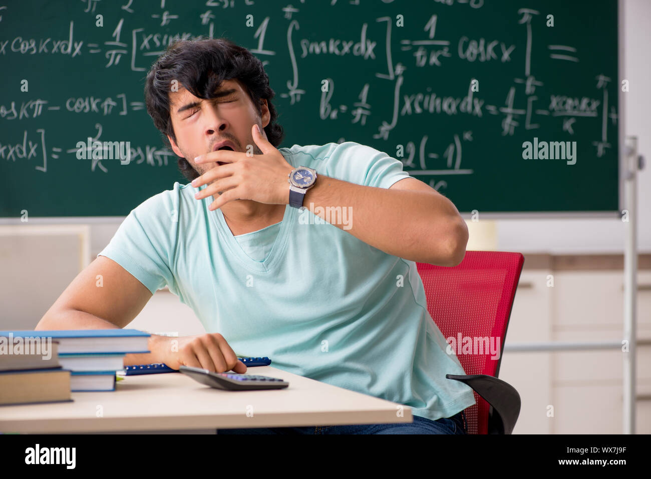 Young male student mathematician in front of chalkboard Stock Photo - Alamy