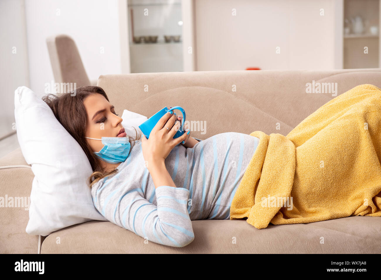 Sick pregnant woman suffering at home Stock Photo - Alamy