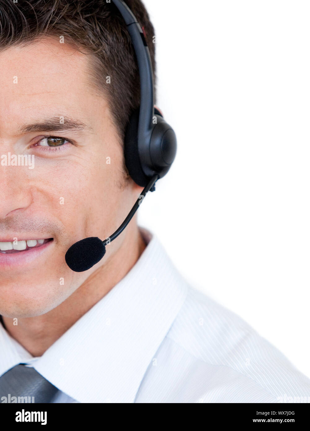 Portrait of a sales representative man with an headset against white ...