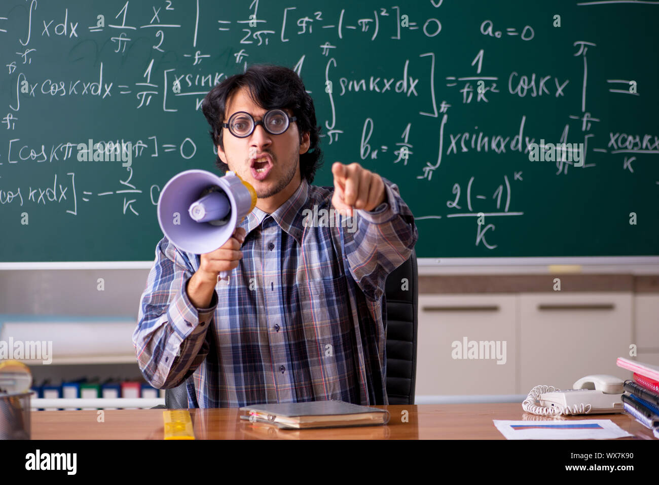 Funny male math teacher in the classroom Stock Photo - Alamy
