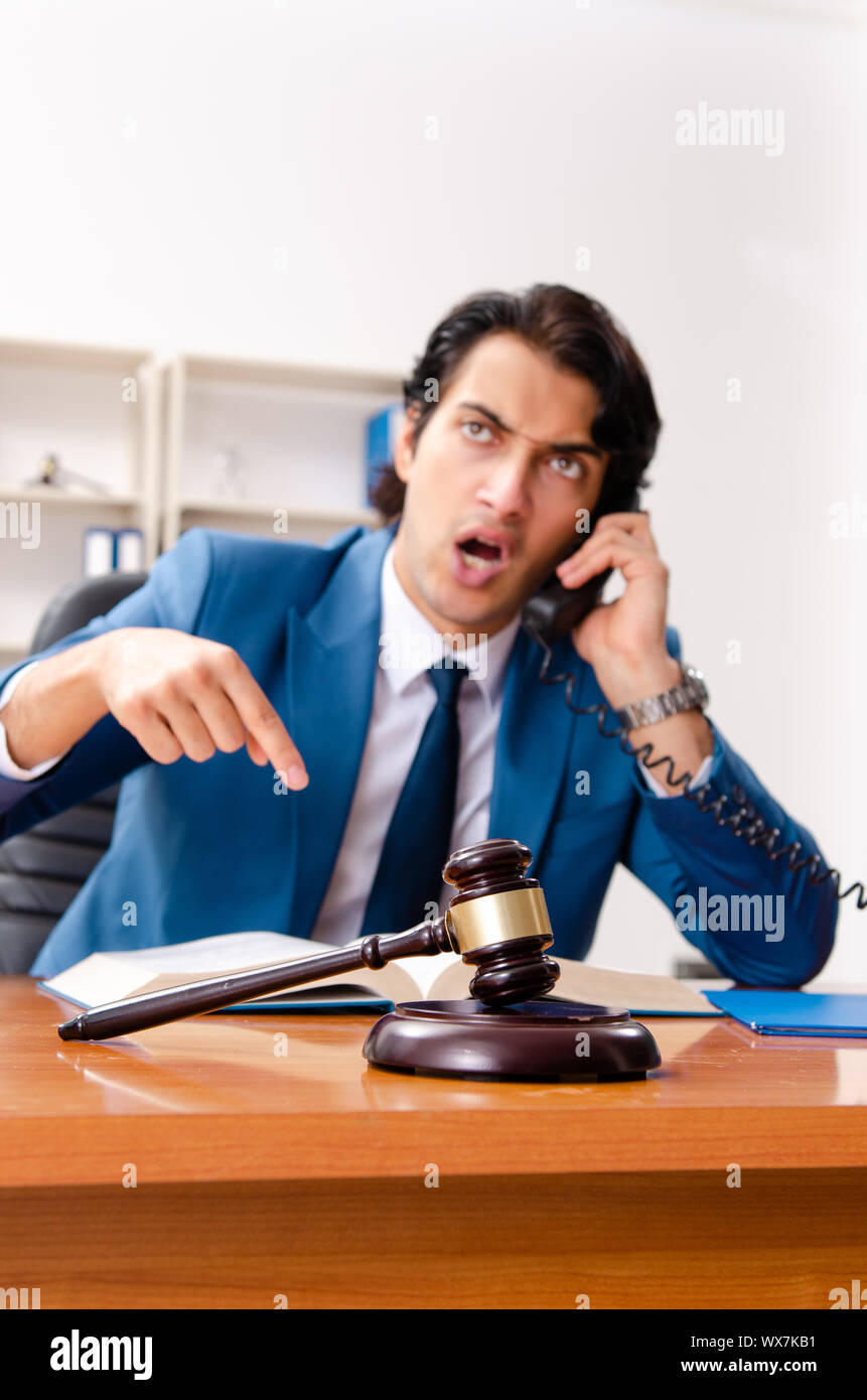 Young handsome judge sitting in courtroom Stock Photo - Alamy