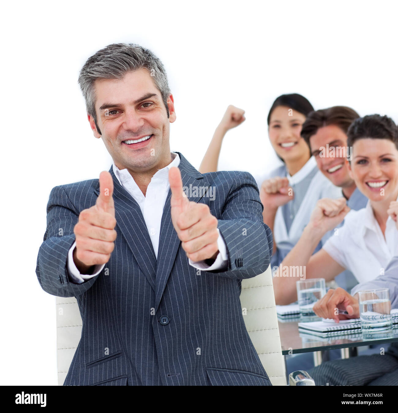 Happy business people celebrating a success against a white background ...