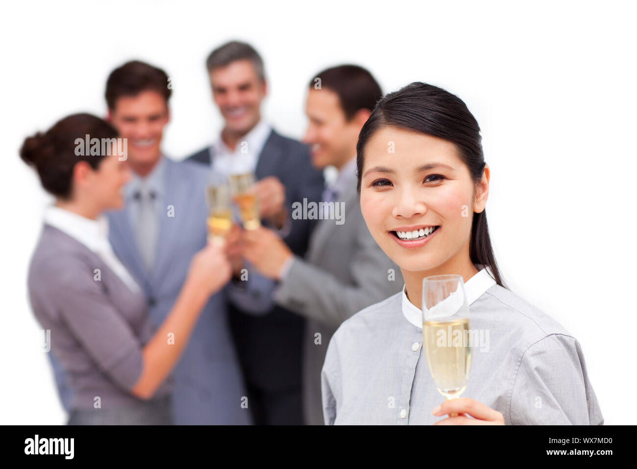 Cheerful manager and her team celebrating a success against a white ...