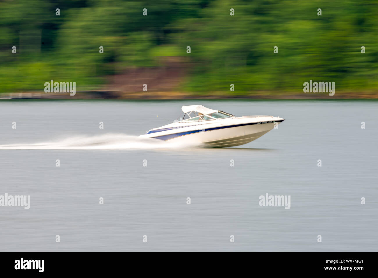 abstract blur of nature and fast moving boat on lake Stock Photo - Alamy
