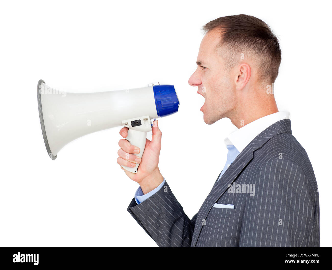 Angry businessman yelling through a megaphone isolated on a white ...