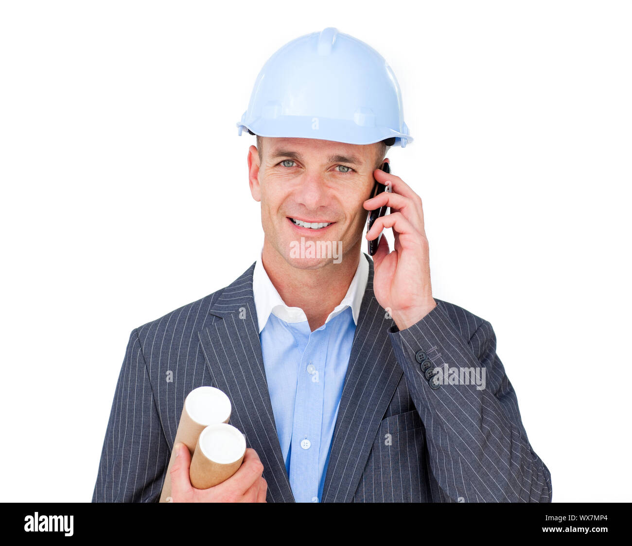 Assertive male engineer talking on phone isolated on a white background ...