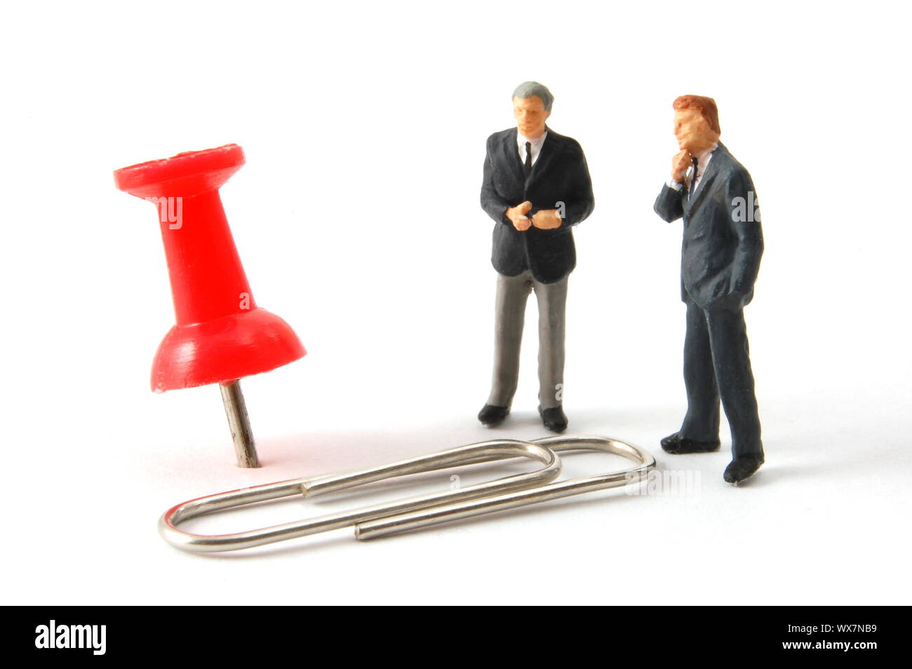 business man and push pin in a office isolated on white background ...