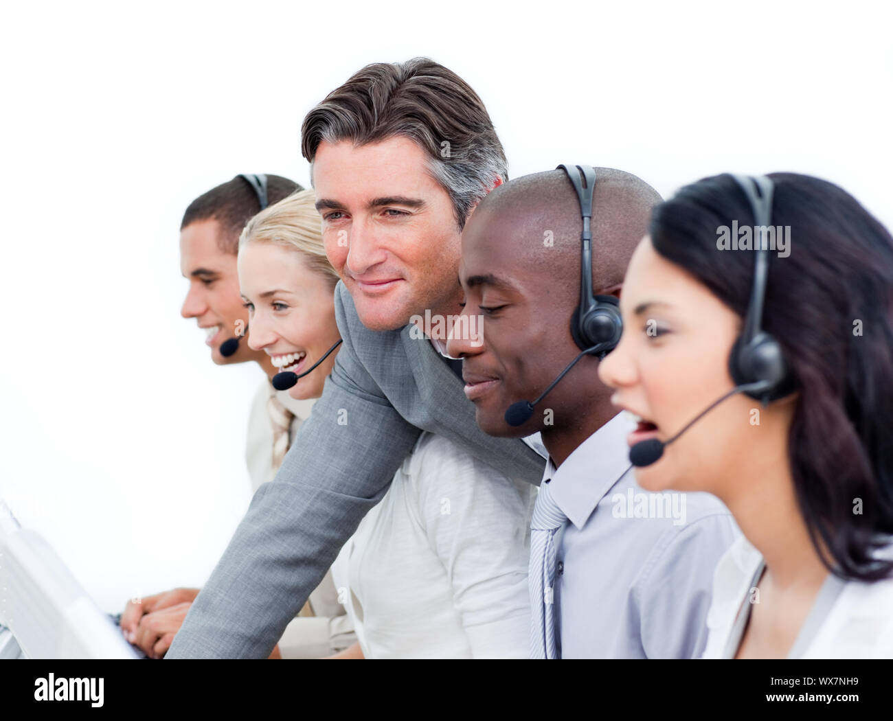 Handsome manager and his team working in a call center against a white ...