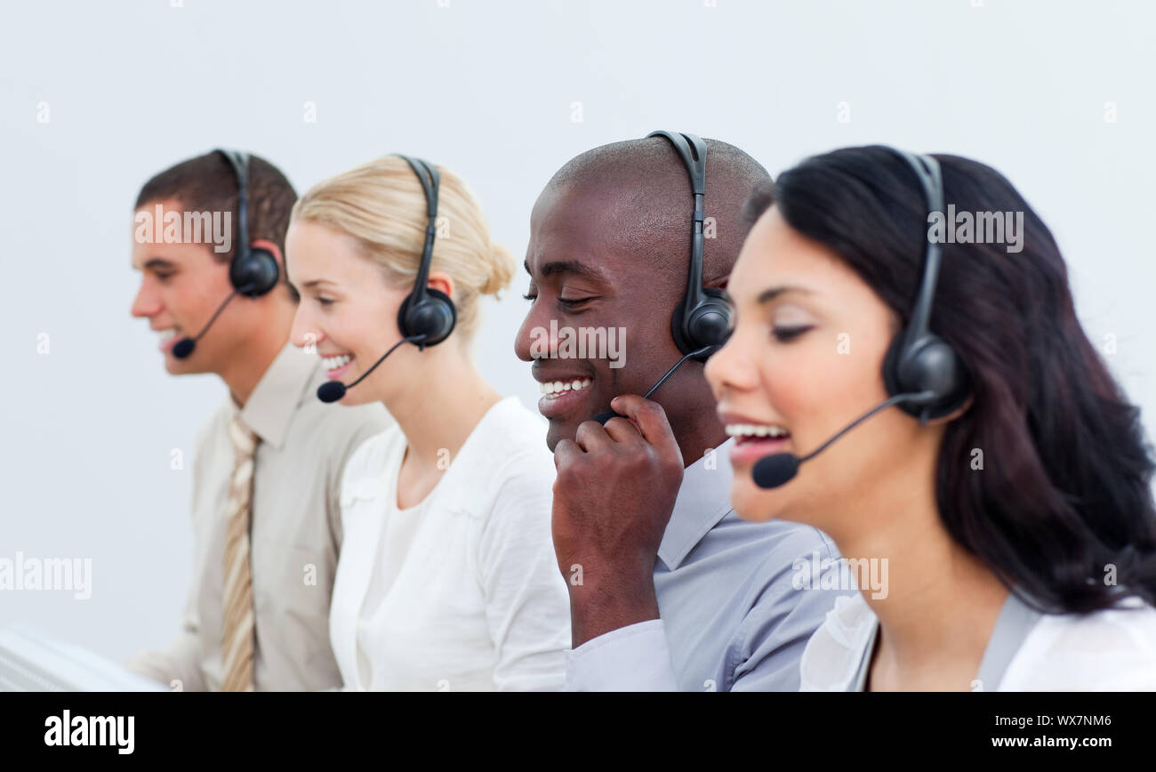 Laughing business people working in a call center in the office Stock ...