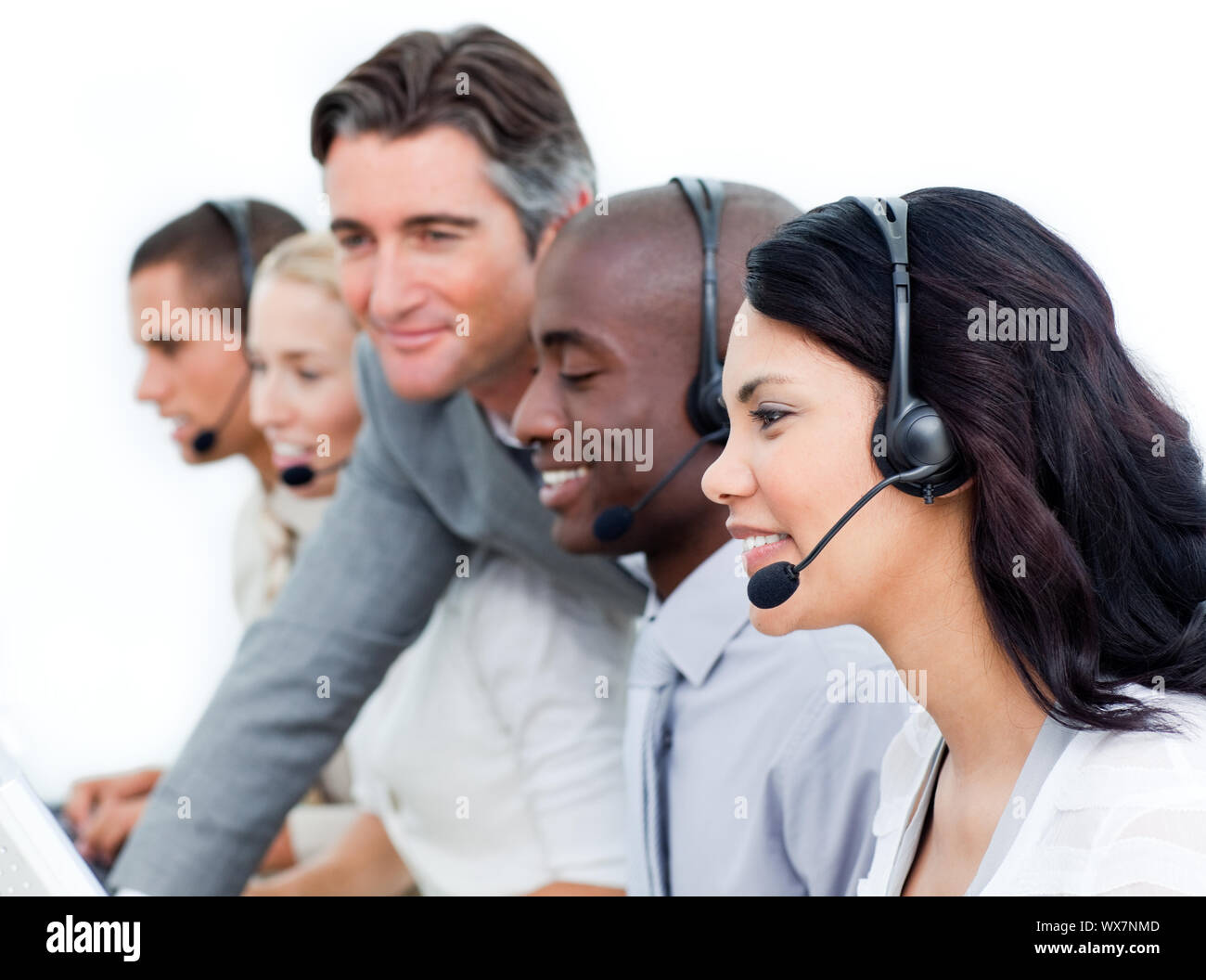 Charismatic manager and his team working in a call center against a ...