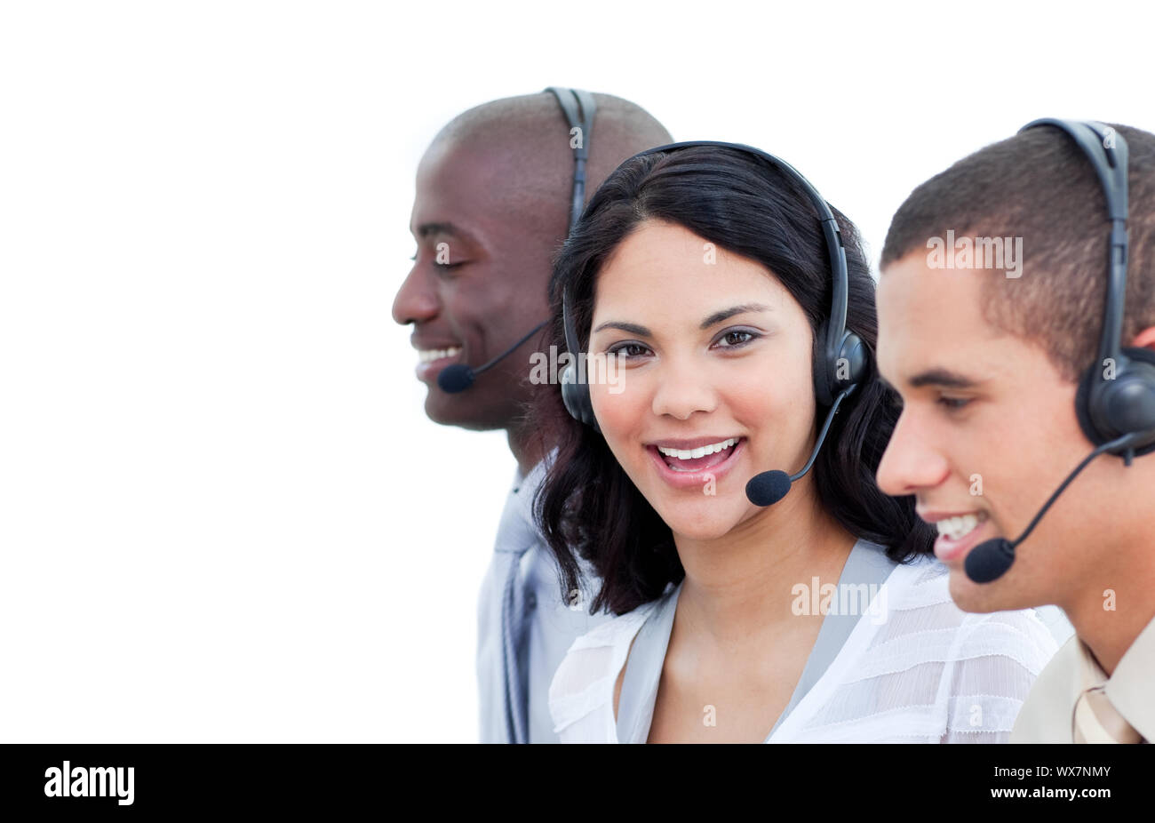 Portrait of a brunette woman and her team working in a call center ...
