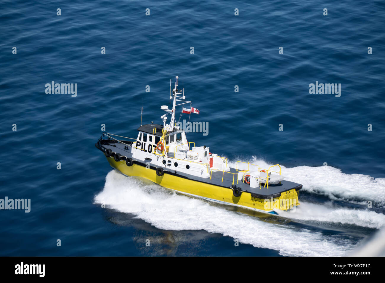 pilot boat leading large ship through the waters Stock Photo - Alamy