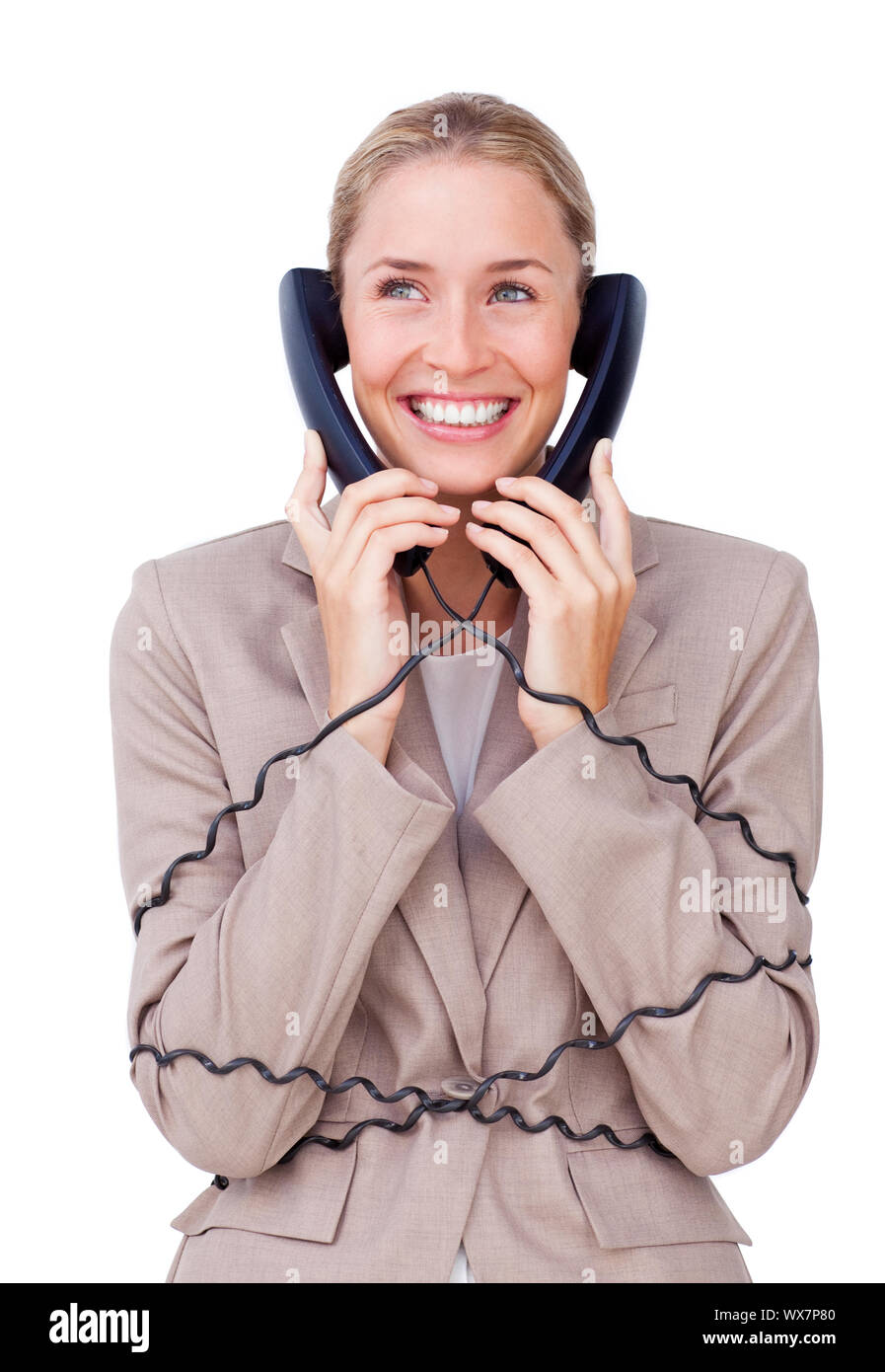 Charming businesswoman tangled up in phone wires against a white ...