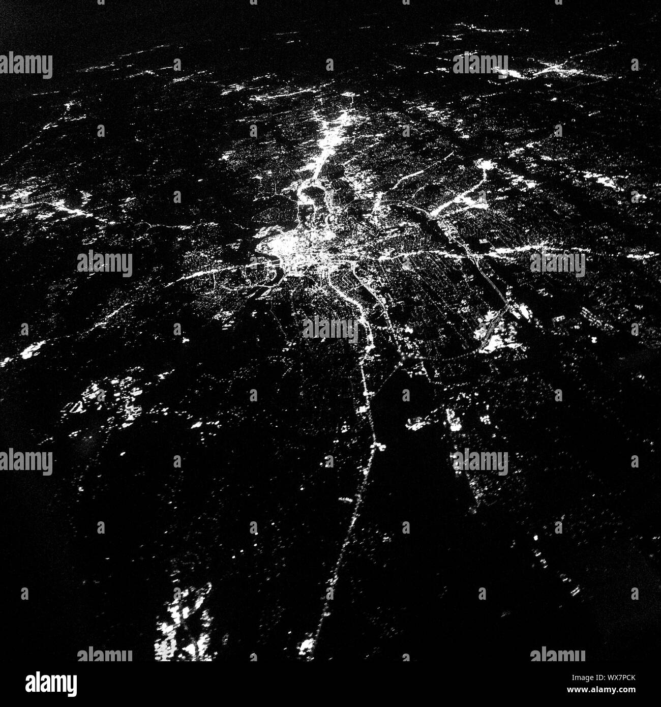 Flying at night over cities below Stock Photo - Alamy